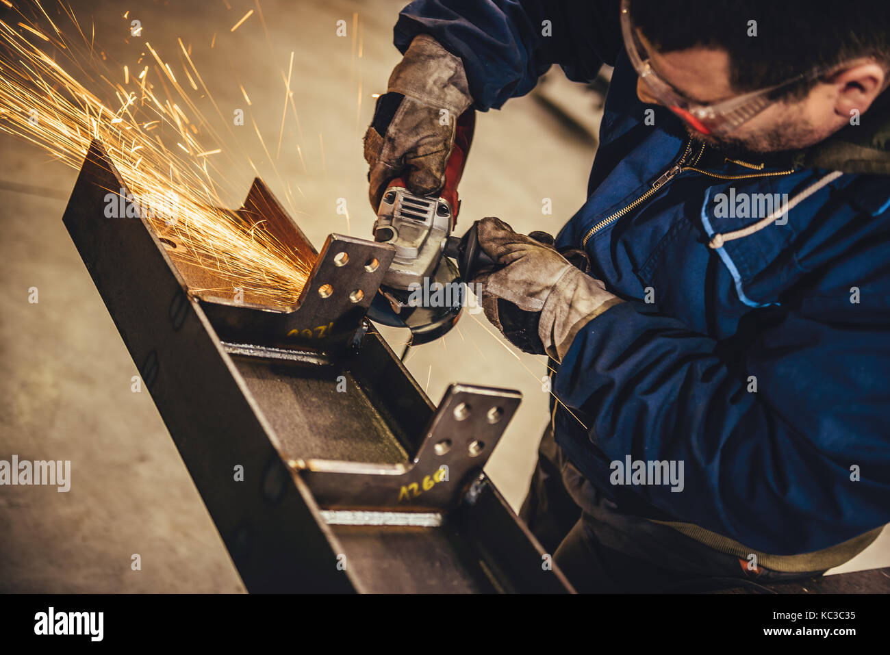 Worker Using Angle Grinder in Factory and throwing sparks Stock Photo ...