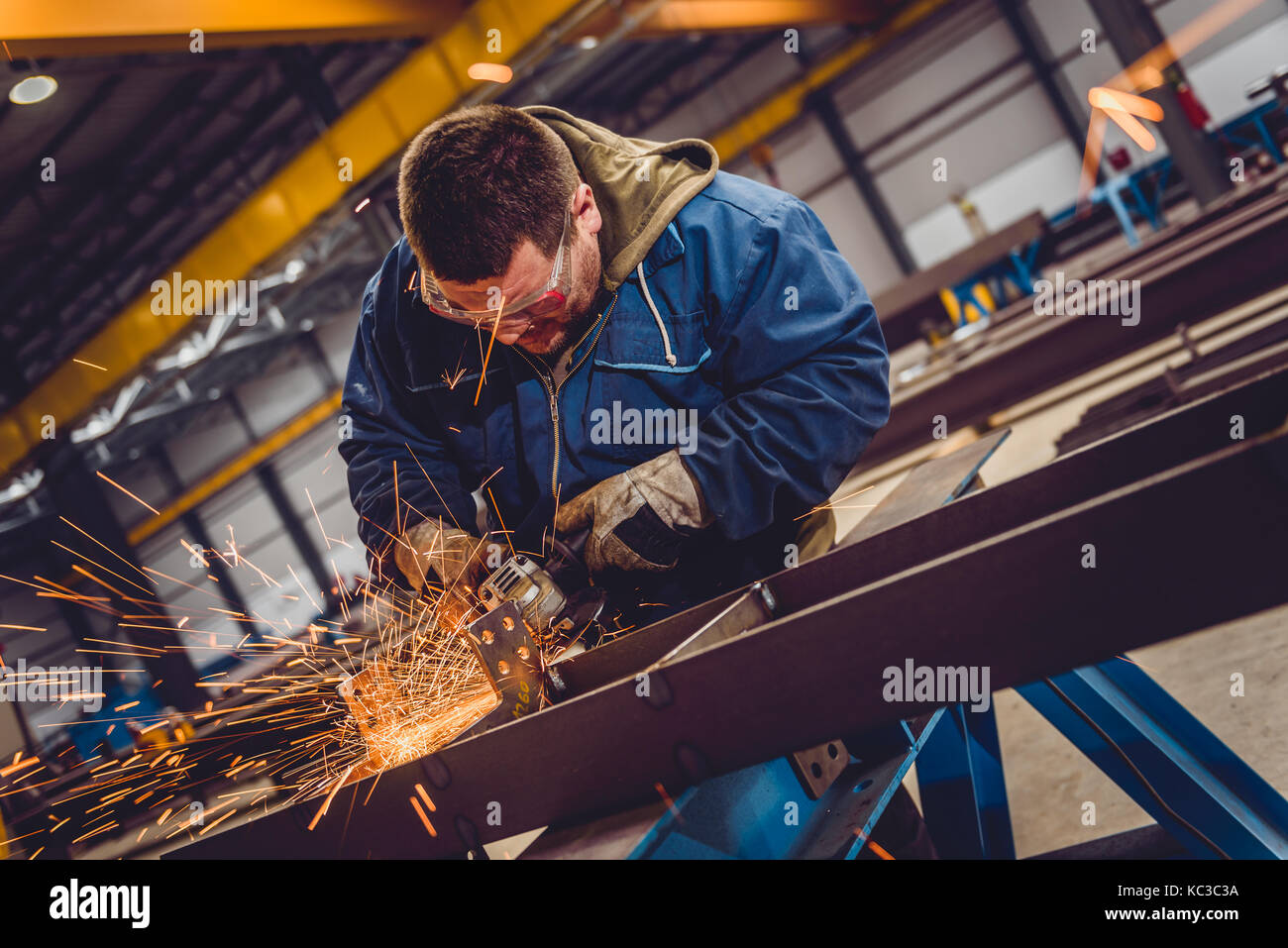 Worker Using Angle Grinder in Factory and throwing sparks Stock Photo ...