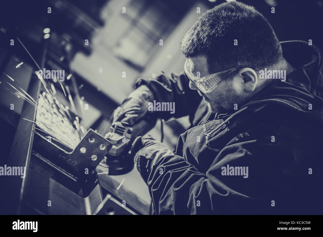Worker Using Angle Grinder in Factory and throwing sparks Stock Photo ...
