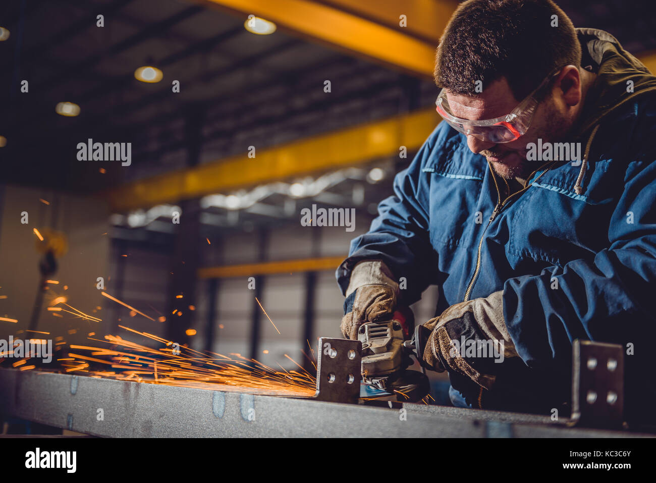 Worker Using Angle Grinder in Factory and throwing sparks Stock Photo ...