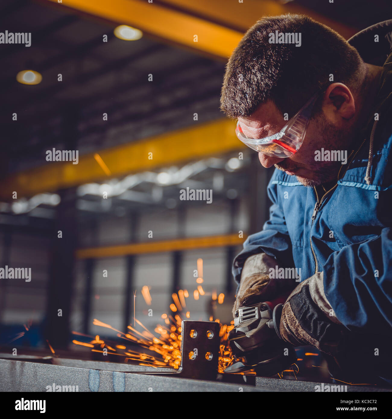 Worker Using Angle Grinder in Factory and throwing sparks Stock Photo ...