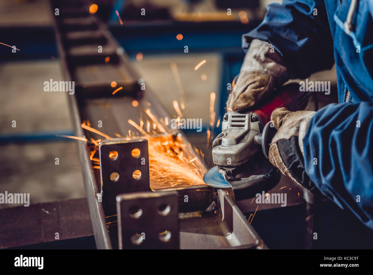 Worker Using Angle Grinder in Factory and throwing sparks Stock Photo ...