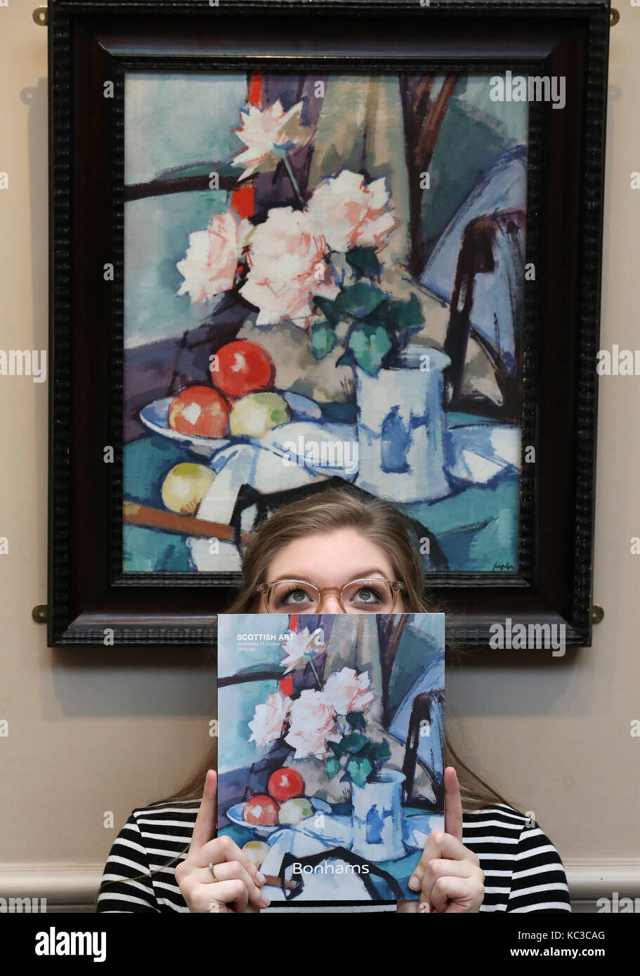 Jaine Heggie of Bonhams with the painting "Still life with Roses in a ...