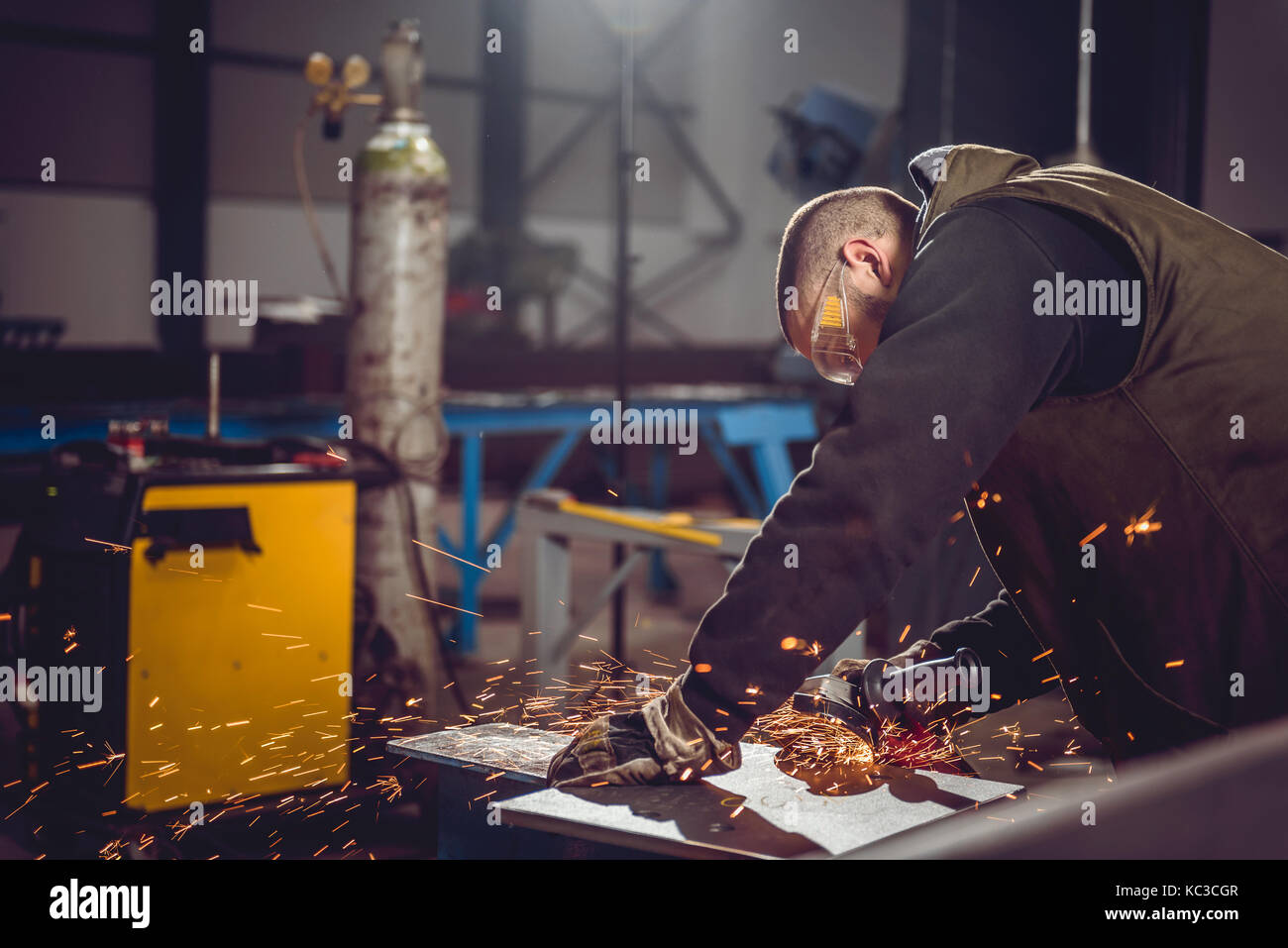 Worker Using Angle Grinder in Factory and throwing sparks Stock Photo ...