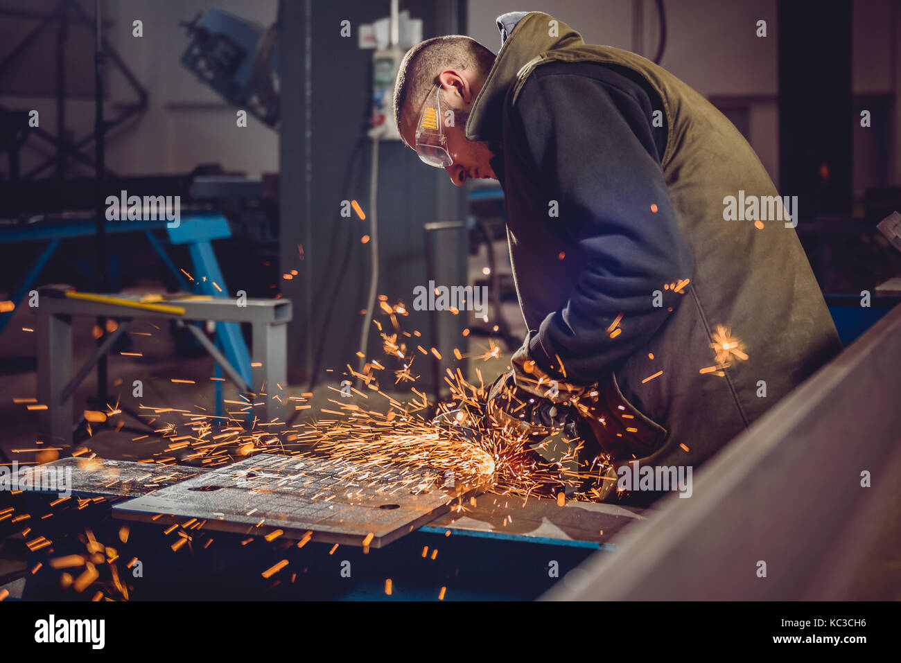Worker Using Angle Grinder in Factory and throwing sparks Stock Photo ...