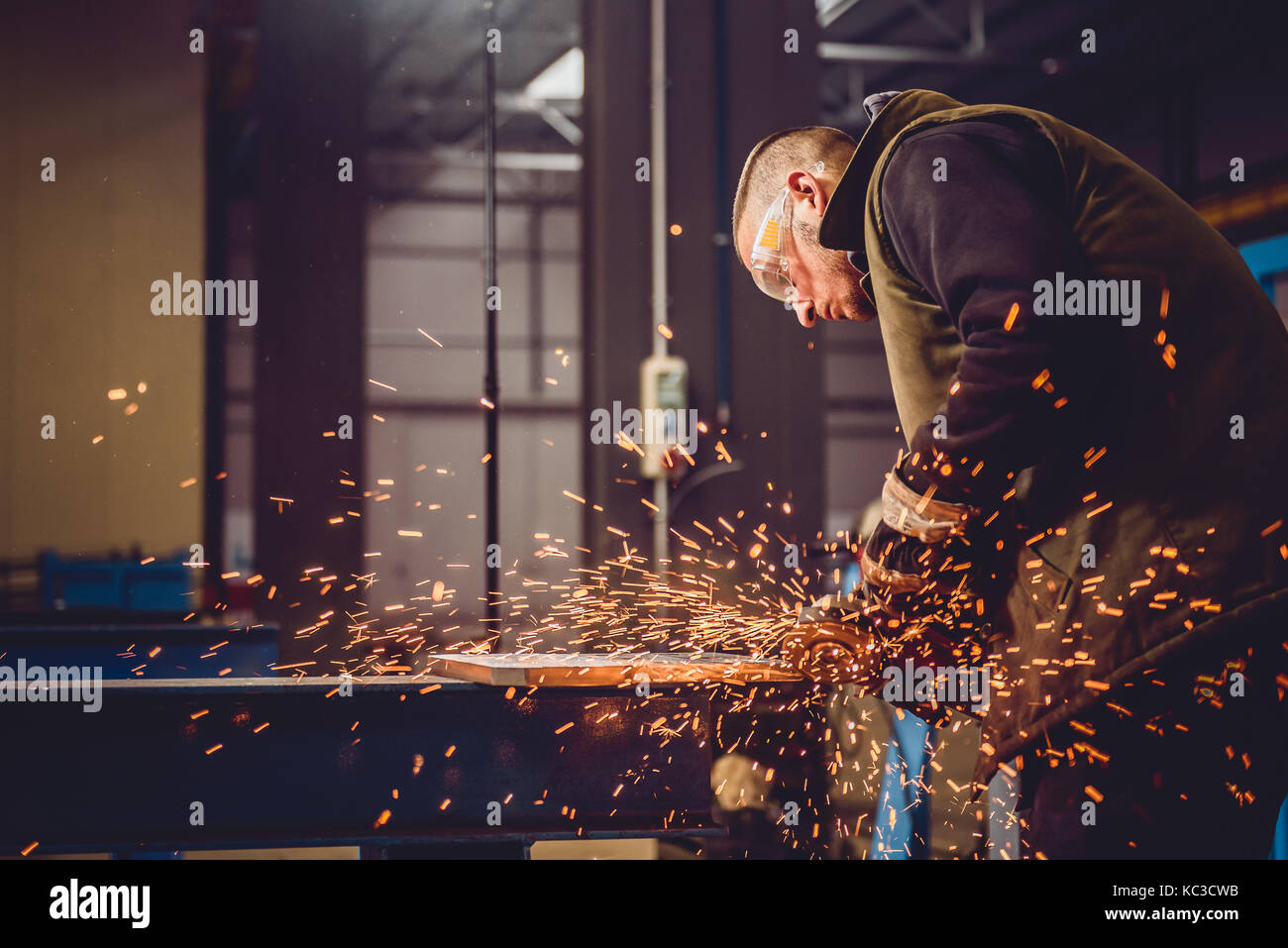Worker Using Angle Grinder in Factory and throwing sparks Stock Photo ...
