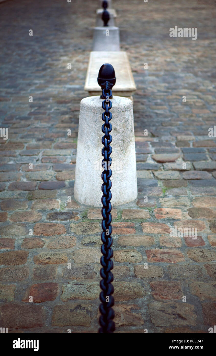 Blocks and stone bench and security chain on a paved square Stock Photo ...