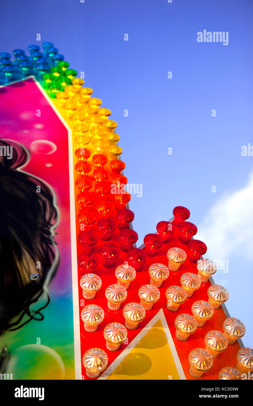 Close up of bulbs and decorative painting of a ride in a fairground ...