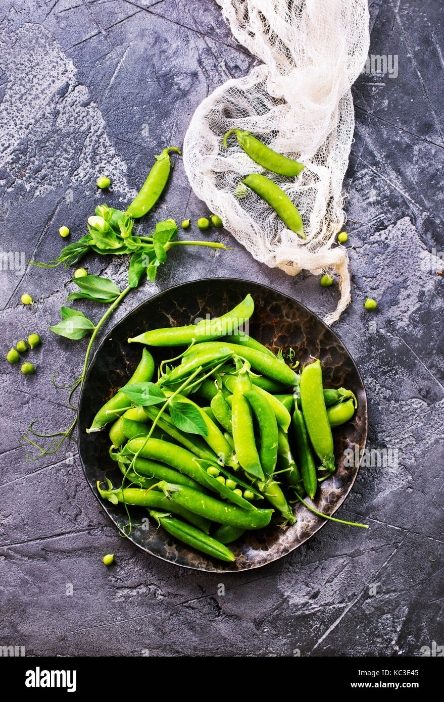 green peas on plate and on a table Stock Photo - Alamy