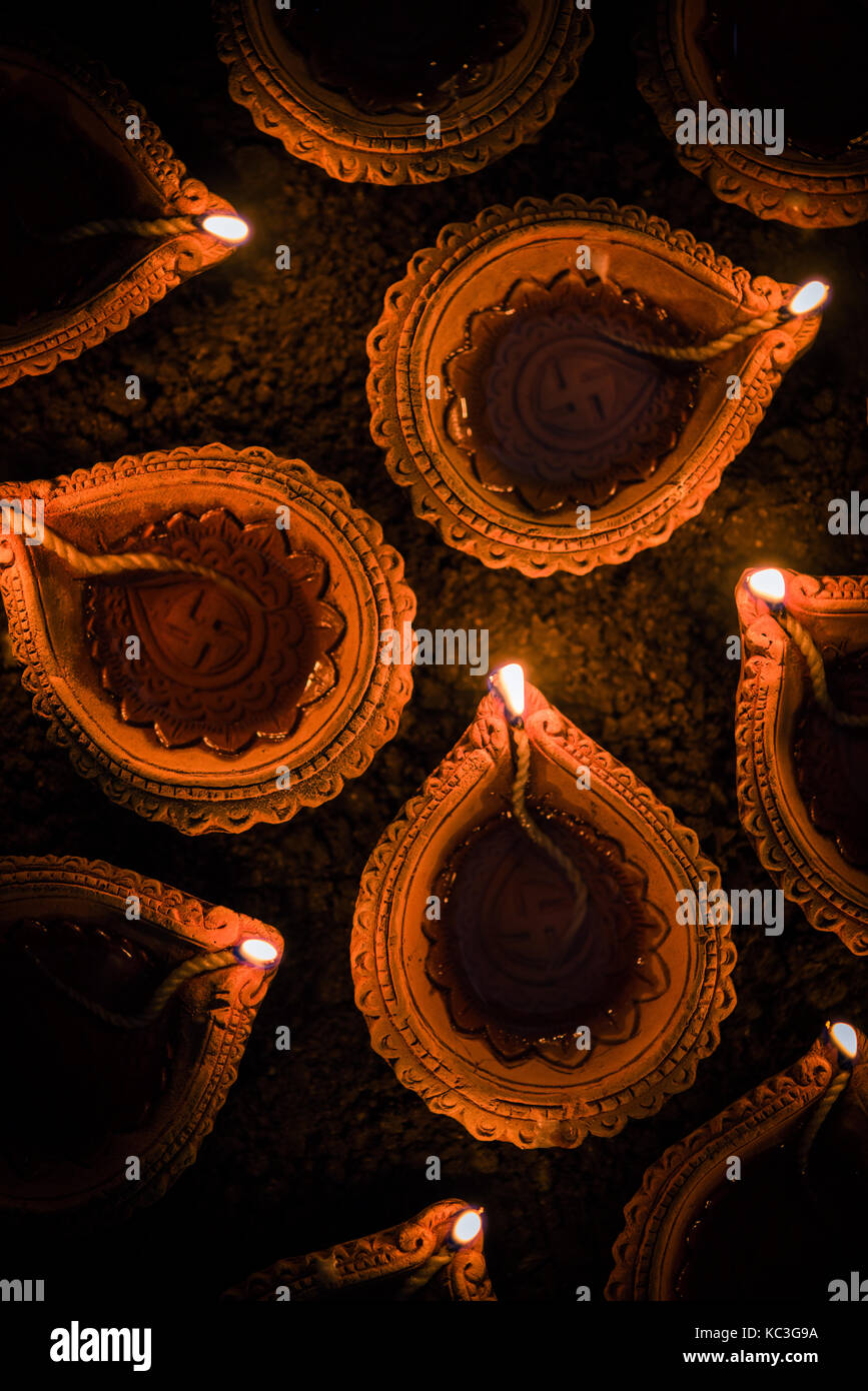 Happy Diwali - Terracotta diya or oil lamps over clay surface or ground ...