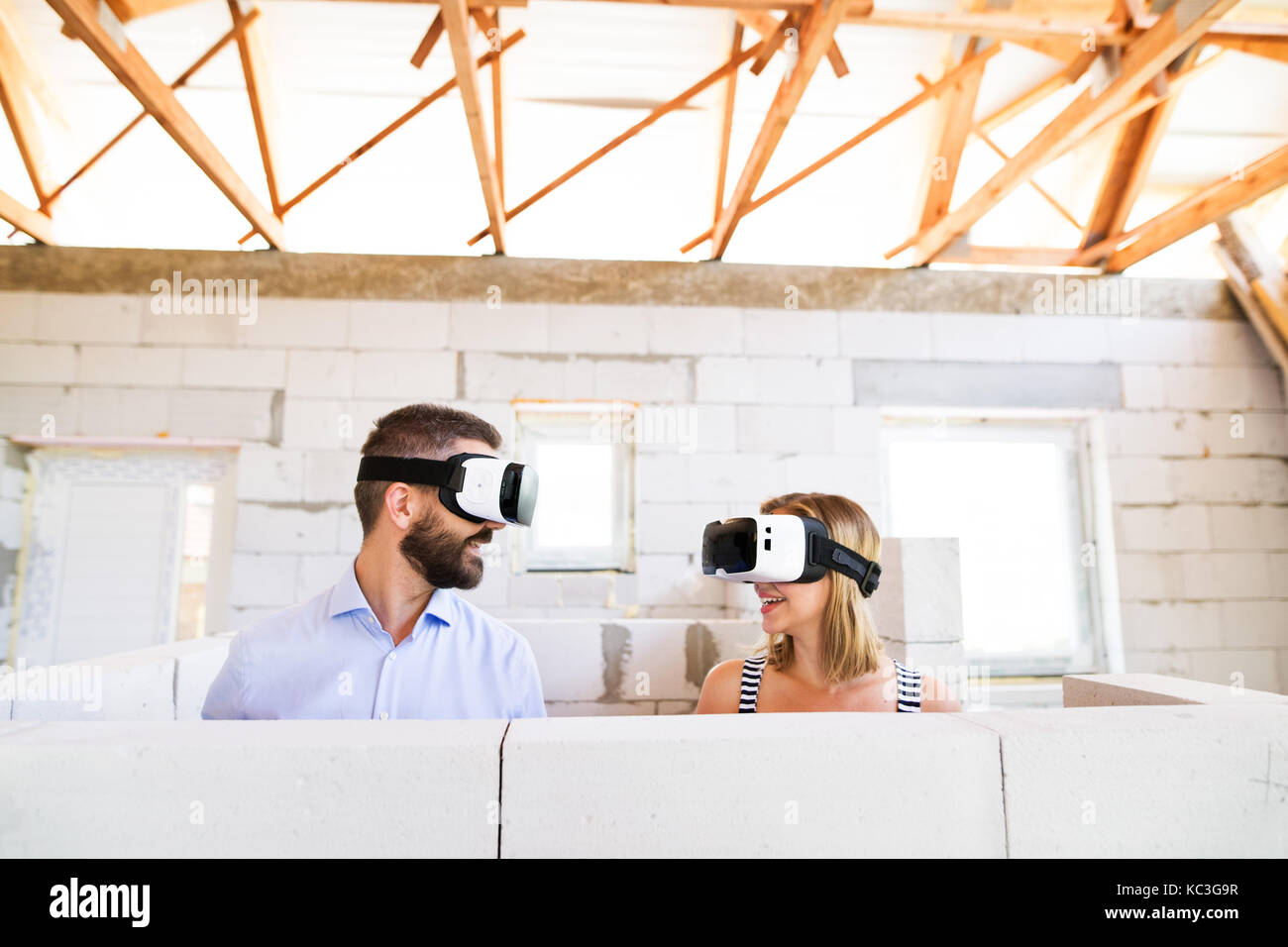 Young married couple at the construction site Stock Photo - Alamy