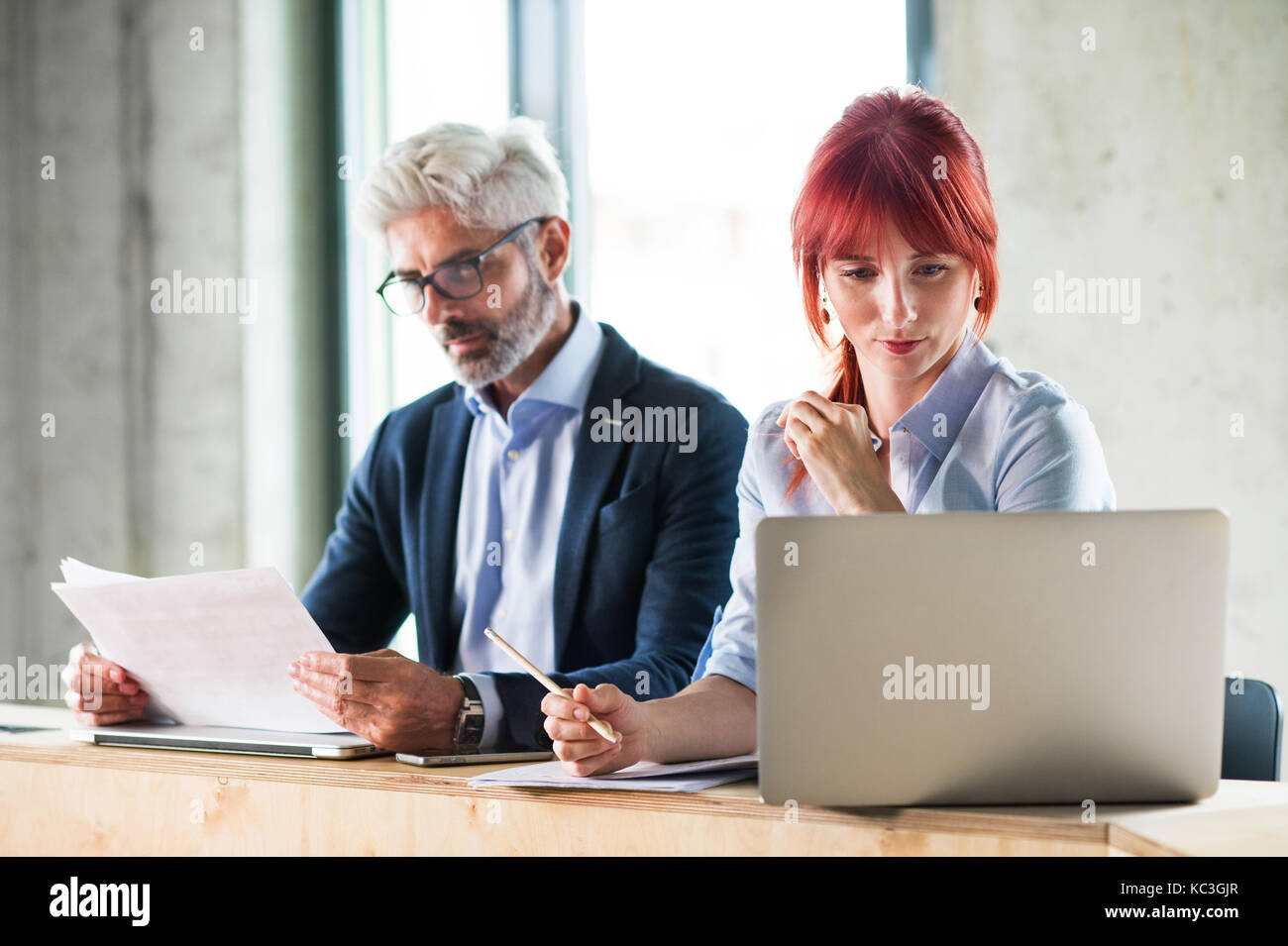 Business people in the office consulting a project Stock Photo - Alamy