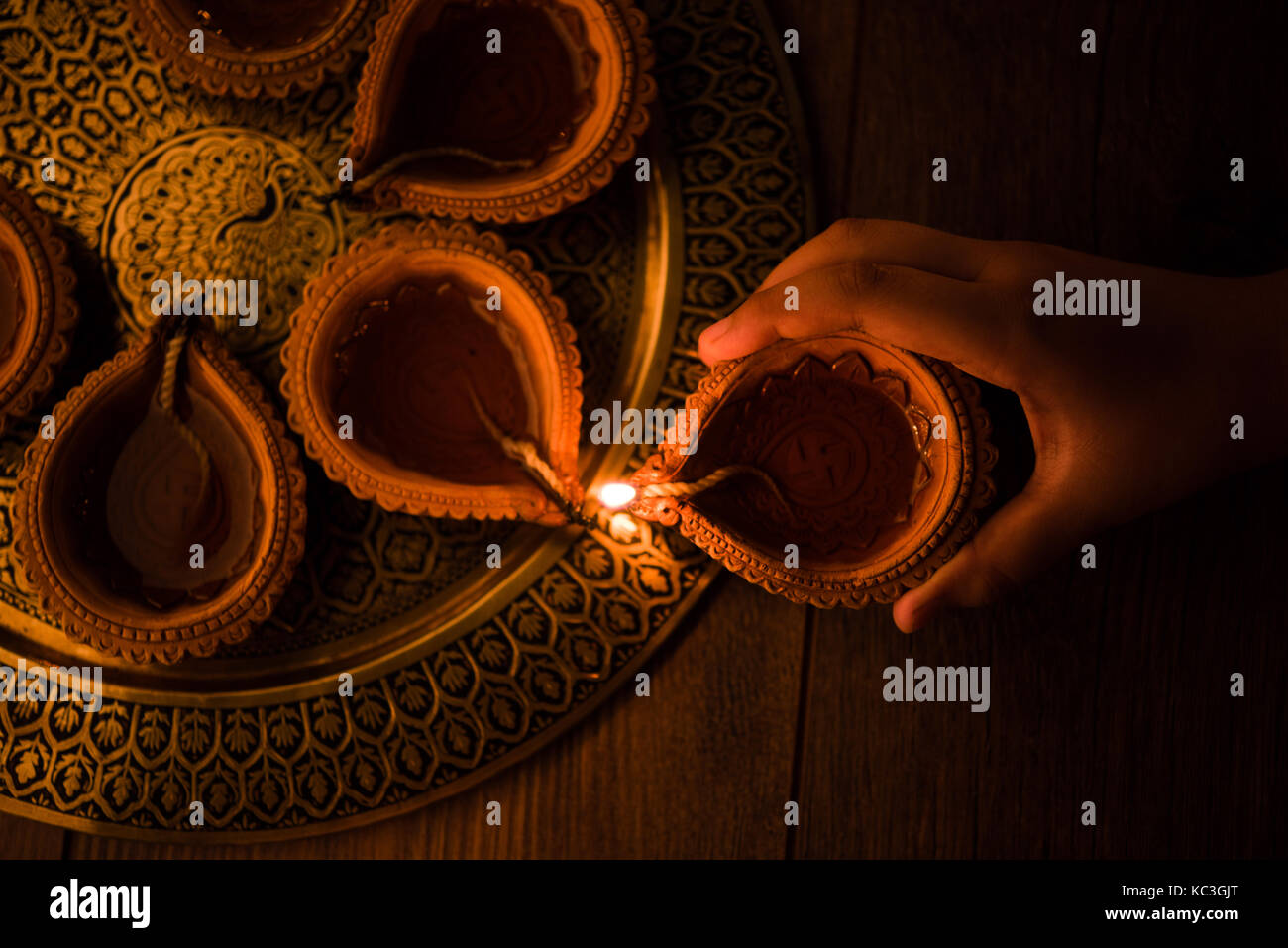 Hand holding diya hi-res stock photography and images - Alamy