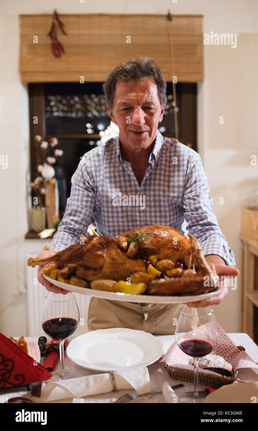 Family celebrating Christmas. Father bringing food Stock Photo - Alamy