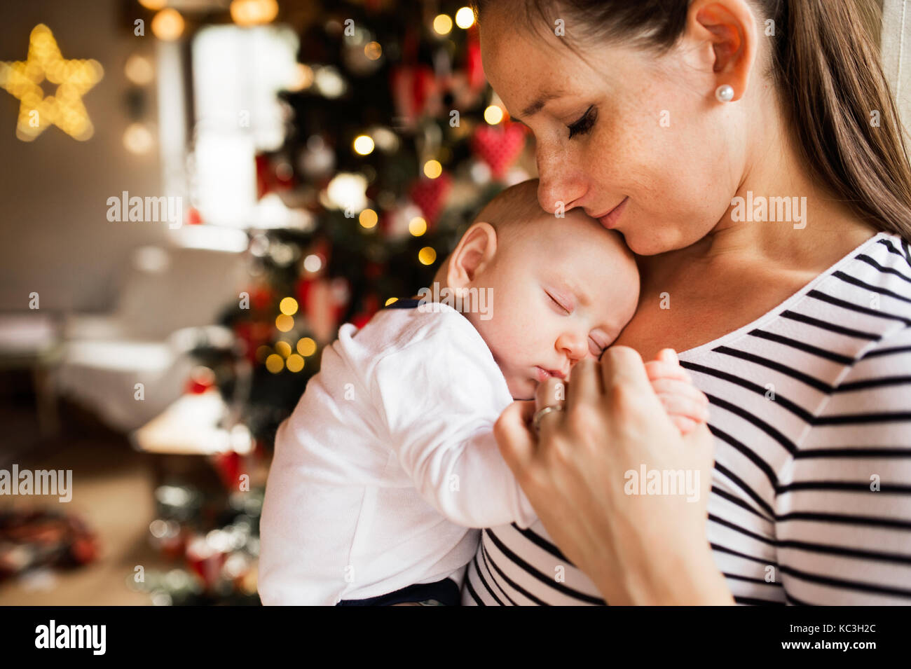 Young woman with a baby boy at Christmas time Stock Photo - Alamy