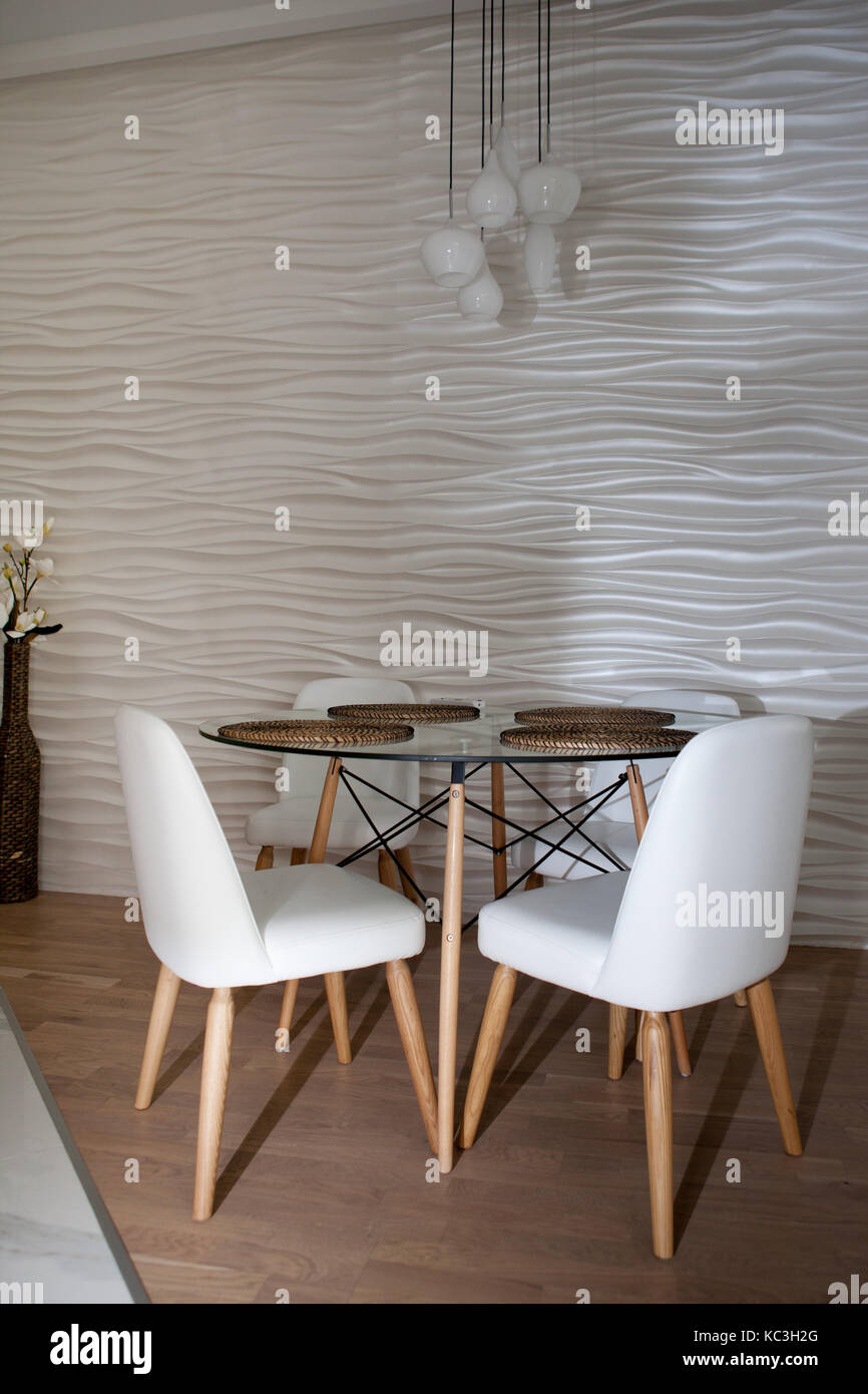 A round table and white chairs and background Stock Photo - Alamy