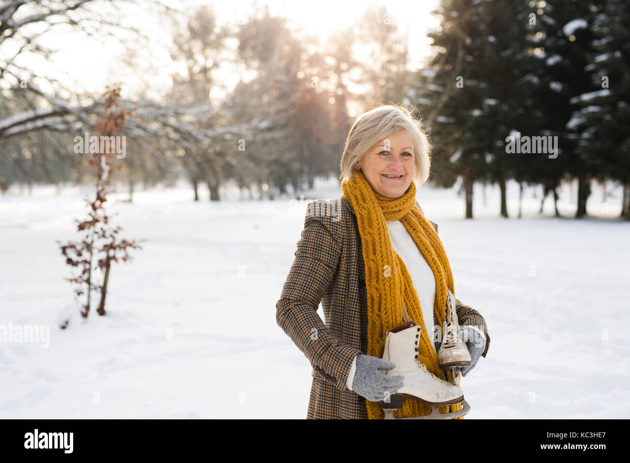 Senior woman in winter nature going ice skating Stock Photo - Alamy