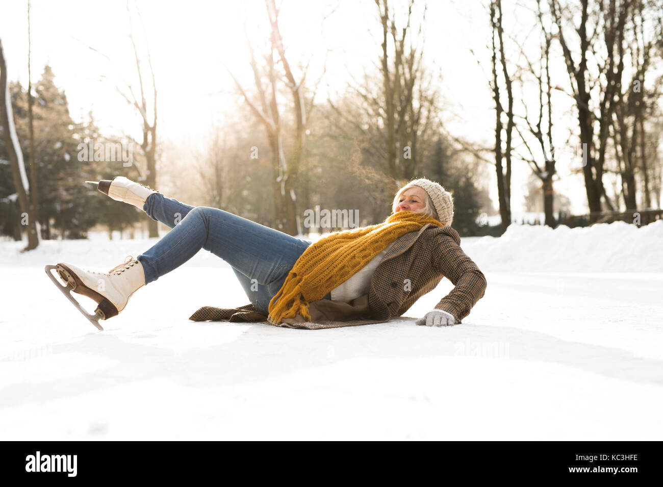 Senior woman on the ice after a fall Stock Photo - Alamy