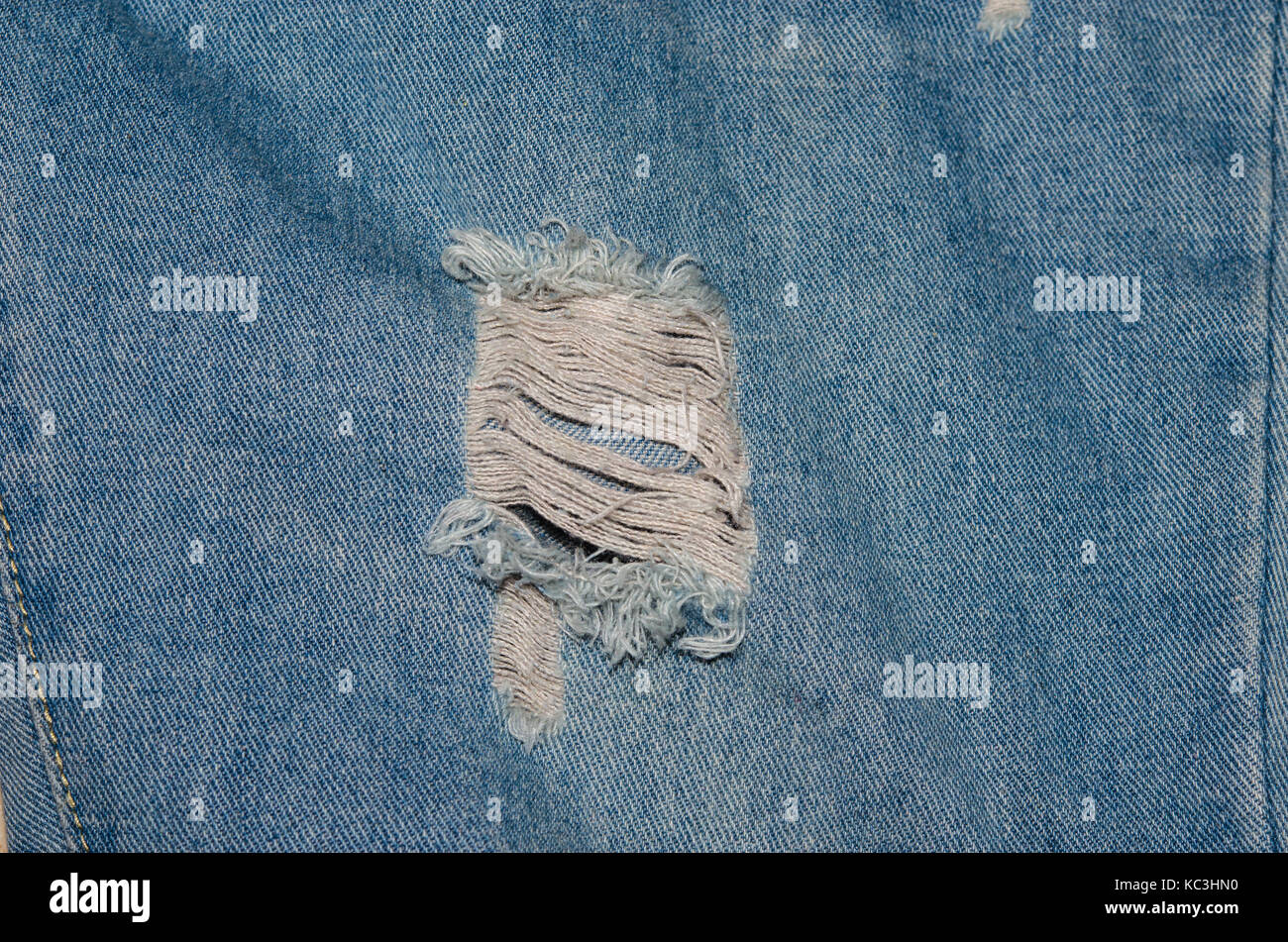 Blue torn jeans texture background Stock Photo - Alamy