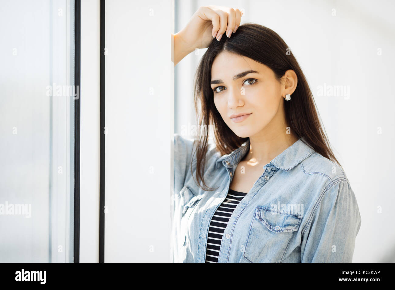 portrait of a beautiful girl on a background of a window Stock Photo ...