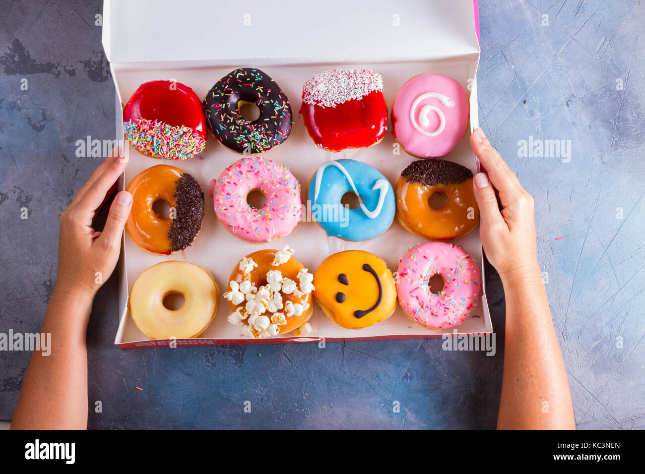 sweet doughnuts on gray stone background Stock Photo - Alamy