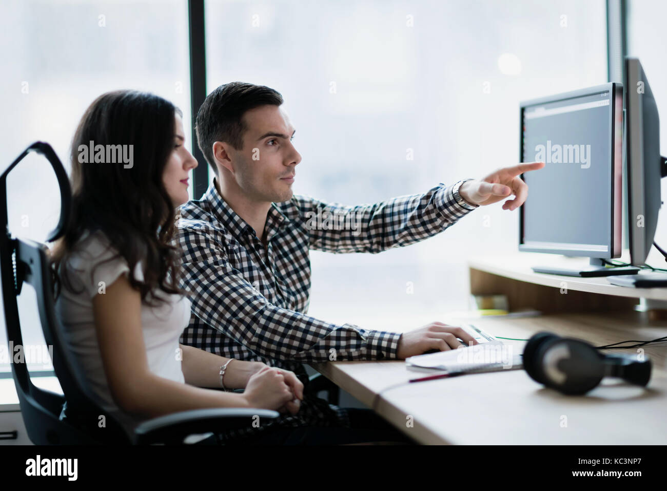 Young businesspeople working on computer in office Stock Photo - Alamy