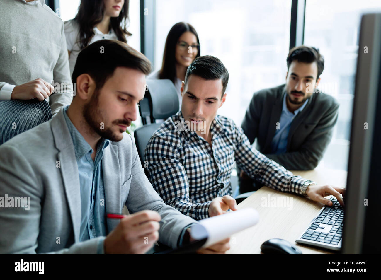 Young businesspeople working on computer in office Stock Photo - Alamy