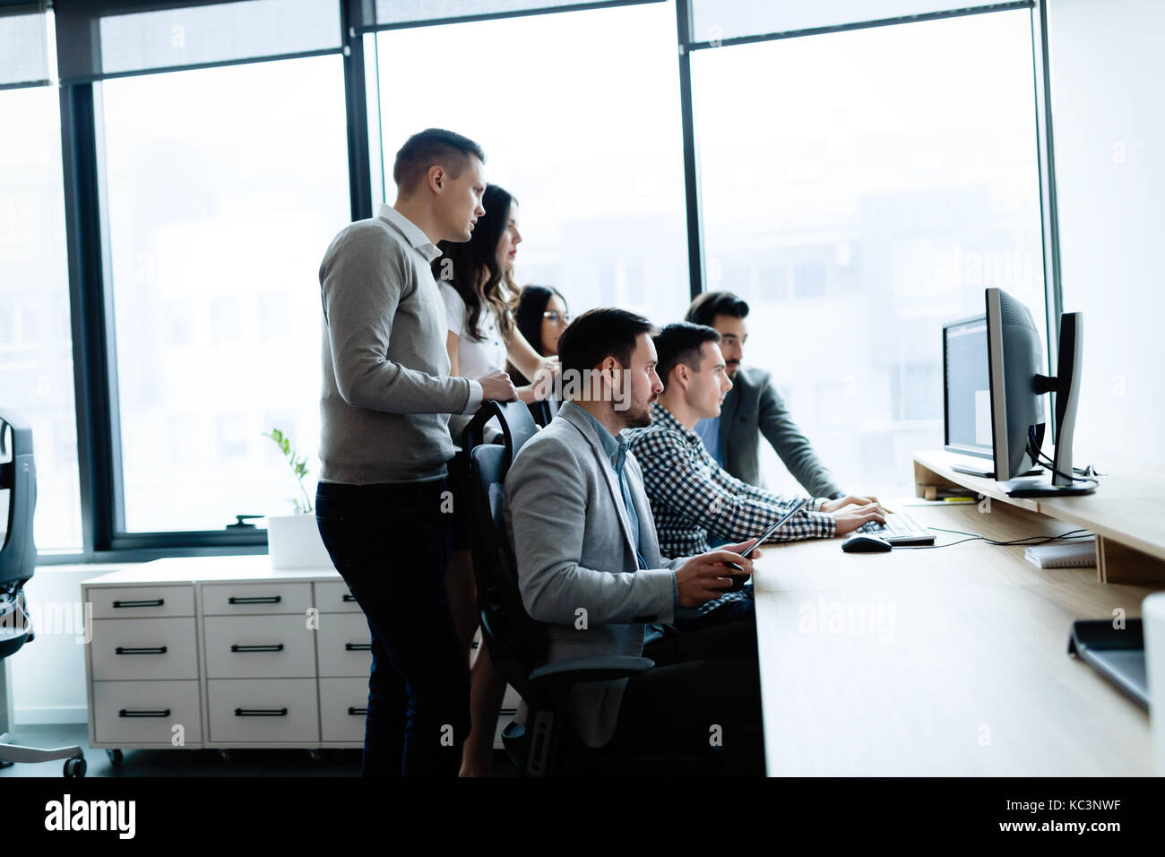 Young businesspeople working on computer in office Stock Photo - Alamy