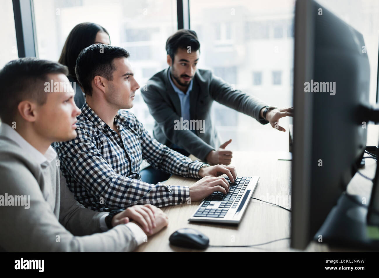 Young businesspeople working on computer in office Stock Photo - Alamy