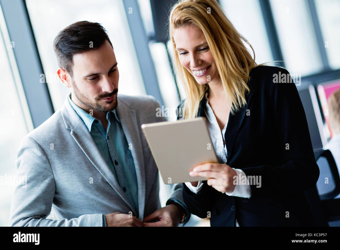 Attractive business couple using tablet in their company Stock Photo ...