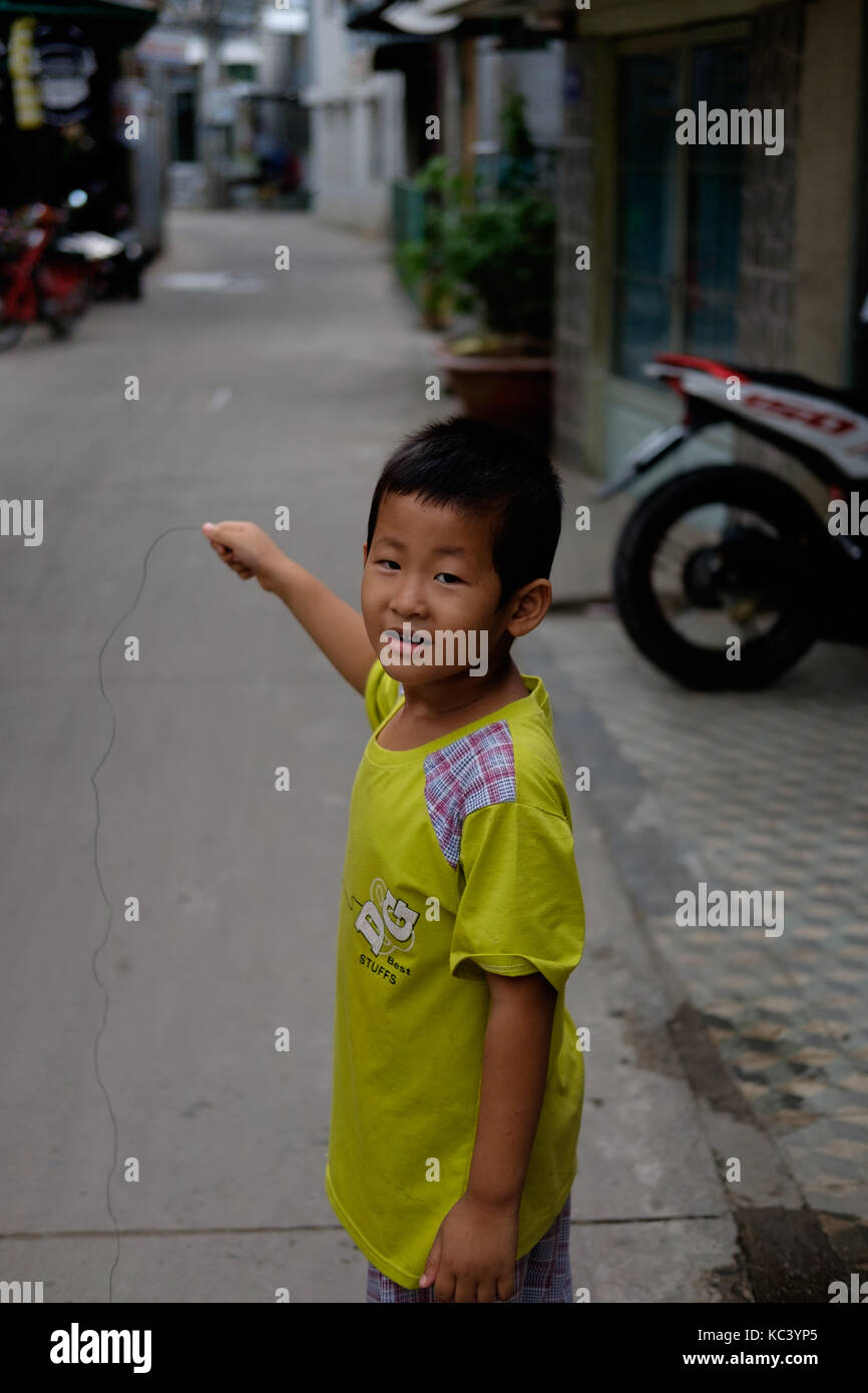 The kid with a cute smile on the street Stock Photo - Alamy