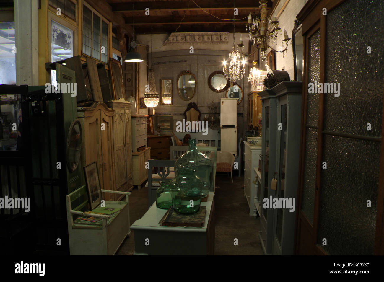 Interior of an antiques shop with cupboards and glass bottles Stock ...