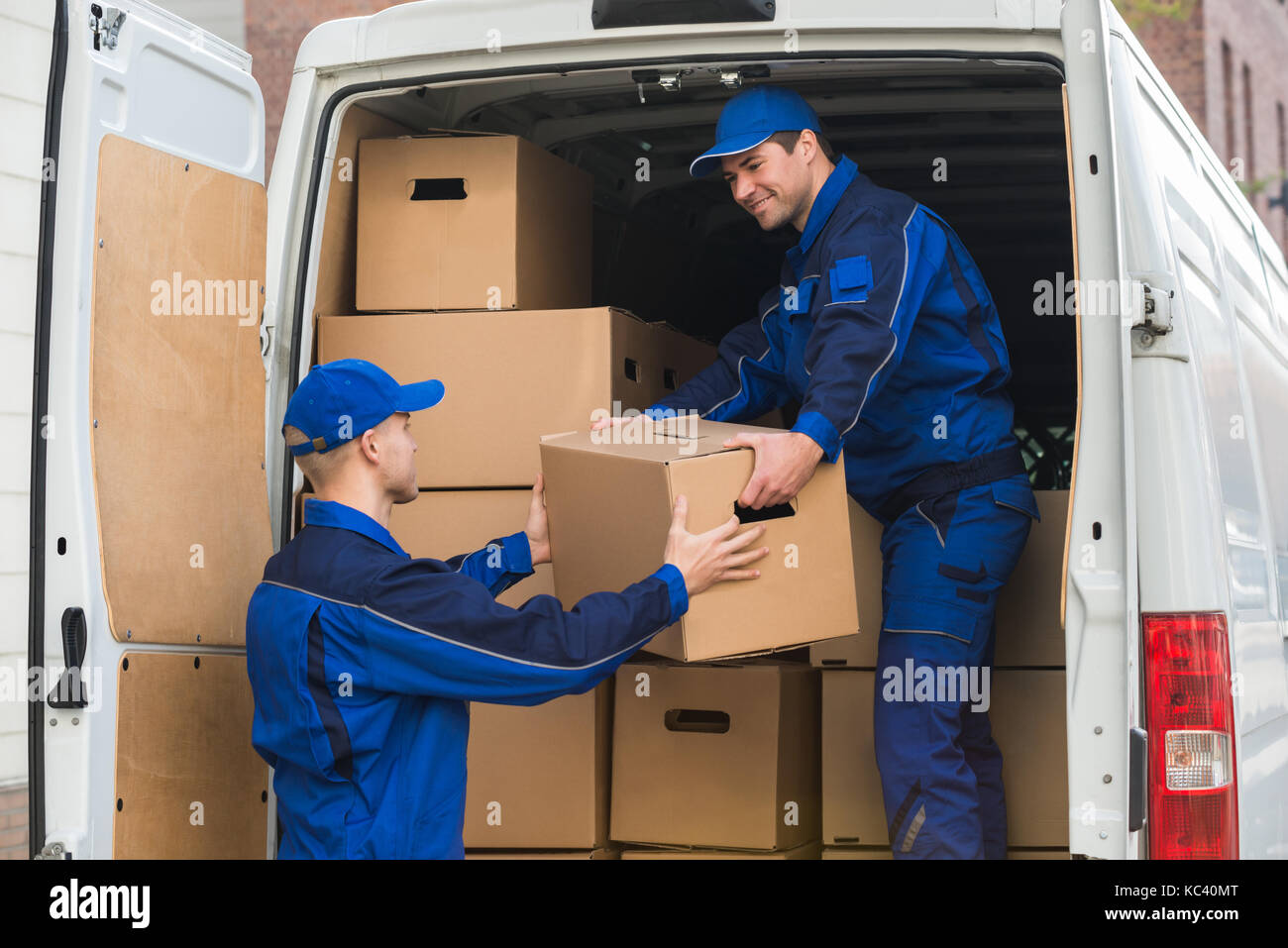 Worker unloading boxes hi-res stock photography and images - Alamy