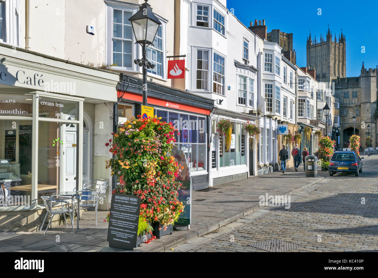 WELLS CITY SOMERSET ENGLAND CATHEDRAL TOWER AND STREET WITH SHOPS ...