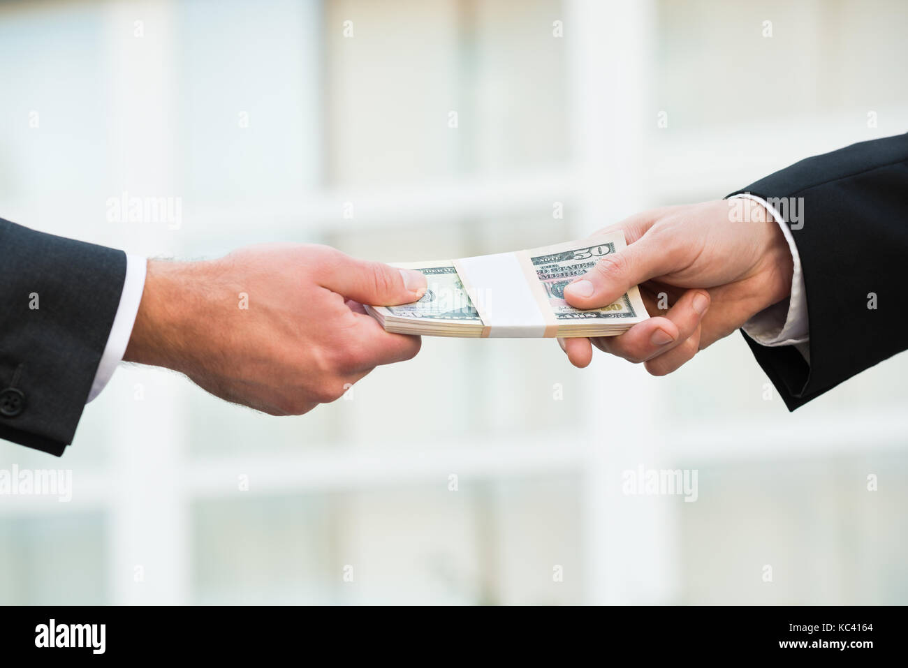 Cropped hand of businessman giving bribe to partner outdoors Stock ...