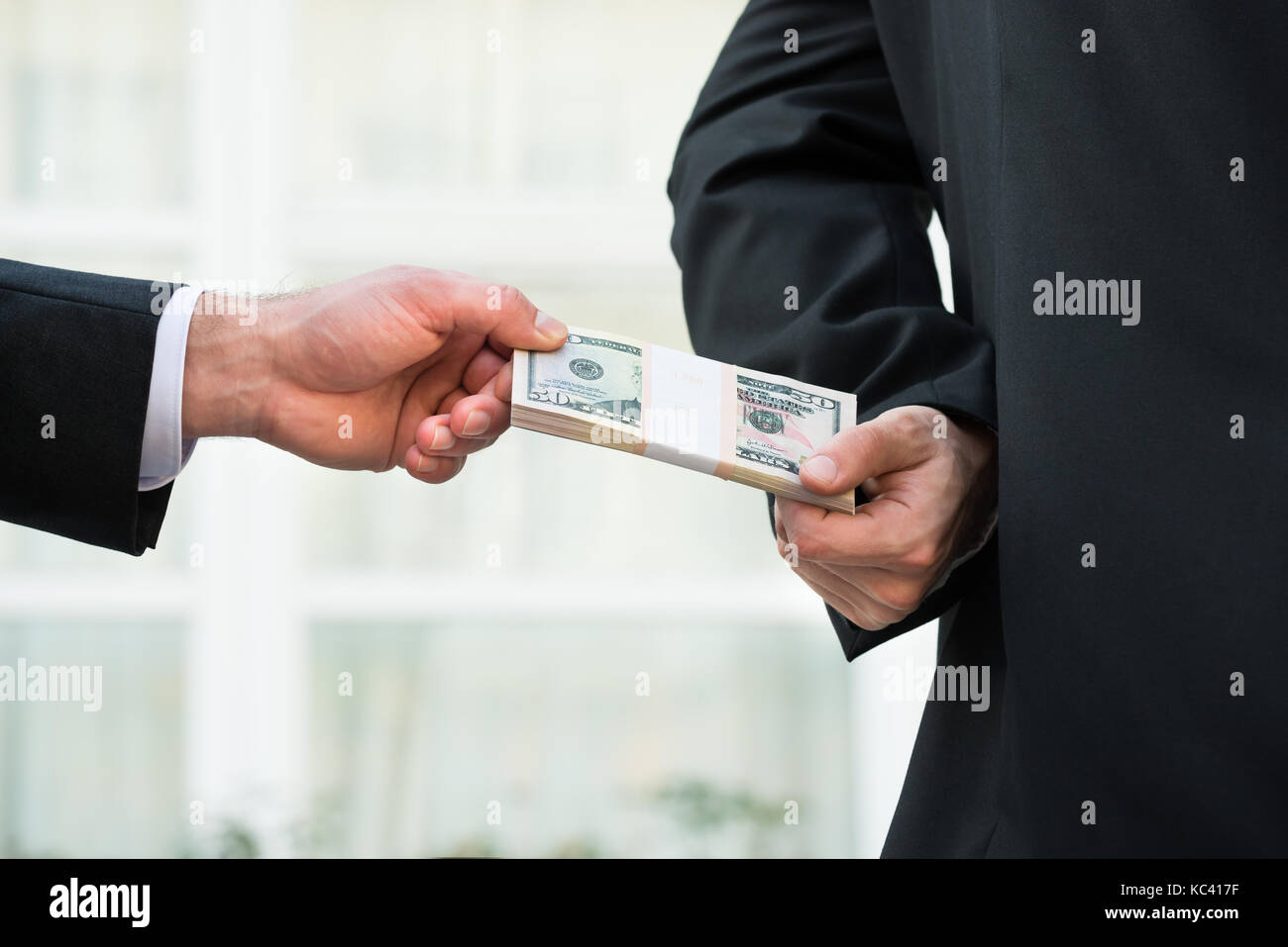 Cropped image of businessman taking bribe from partner outdoors Stock ...
