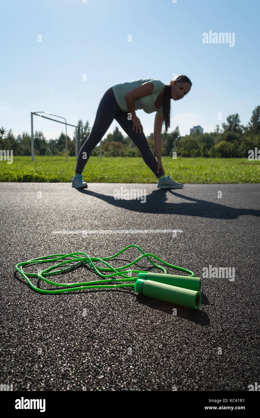 The rope lies on the treadmill, and in the background the girl ...