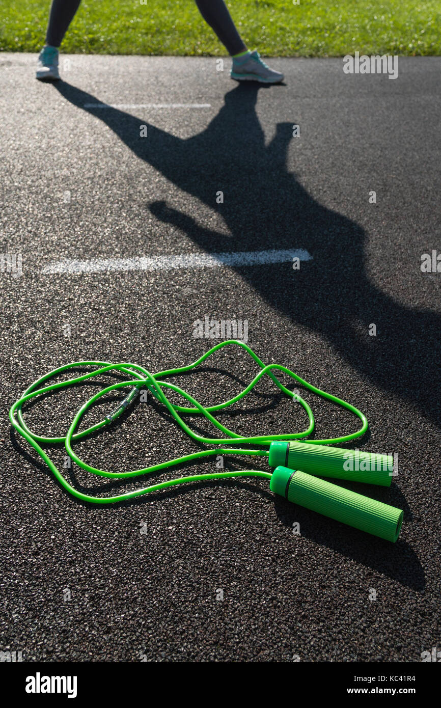 The rope lies on the treadmill, and in the background the girl ...