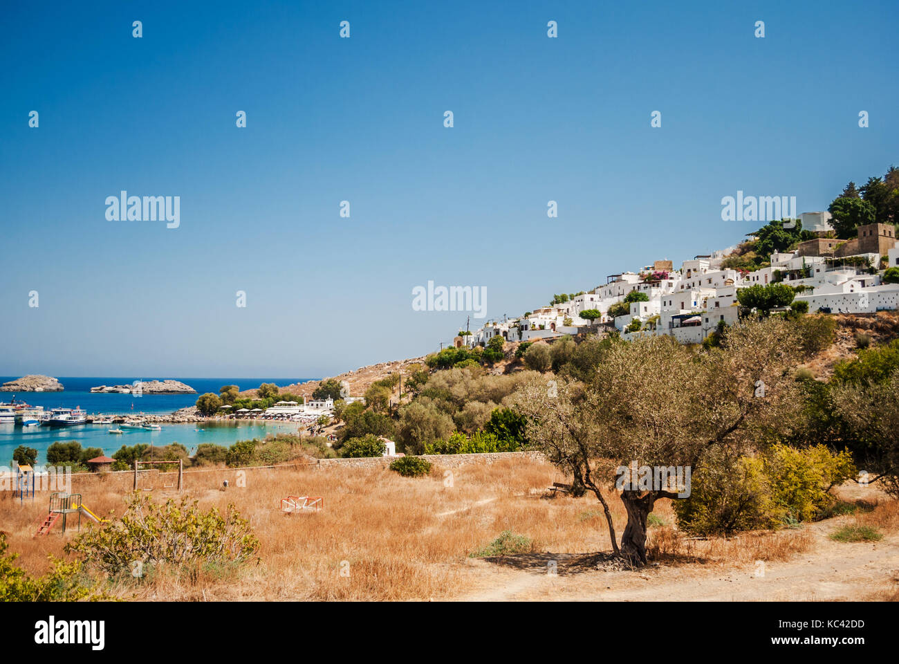 Medieval castle on Acropolis of Lindos with blue bay beneath, Rhodes ...