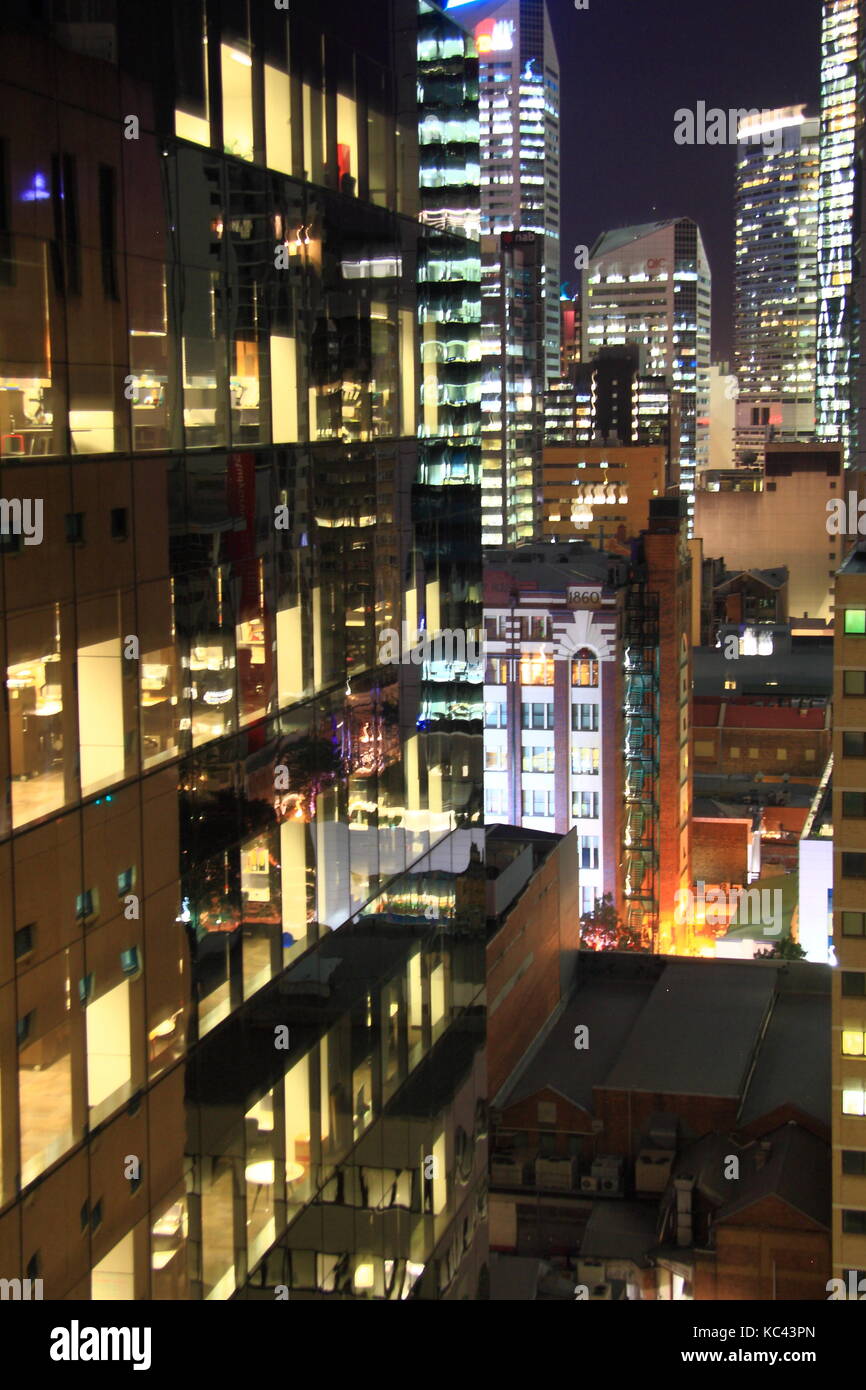 City buildings at night lit up by internal lights show a mosaic of ...