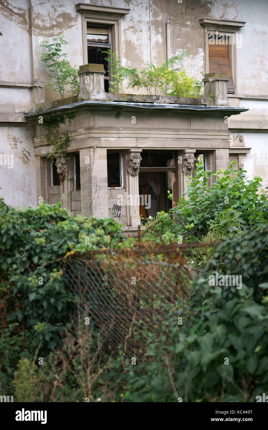 An old abandoned and run-down villa with unkempt front yard Stock Photo ...