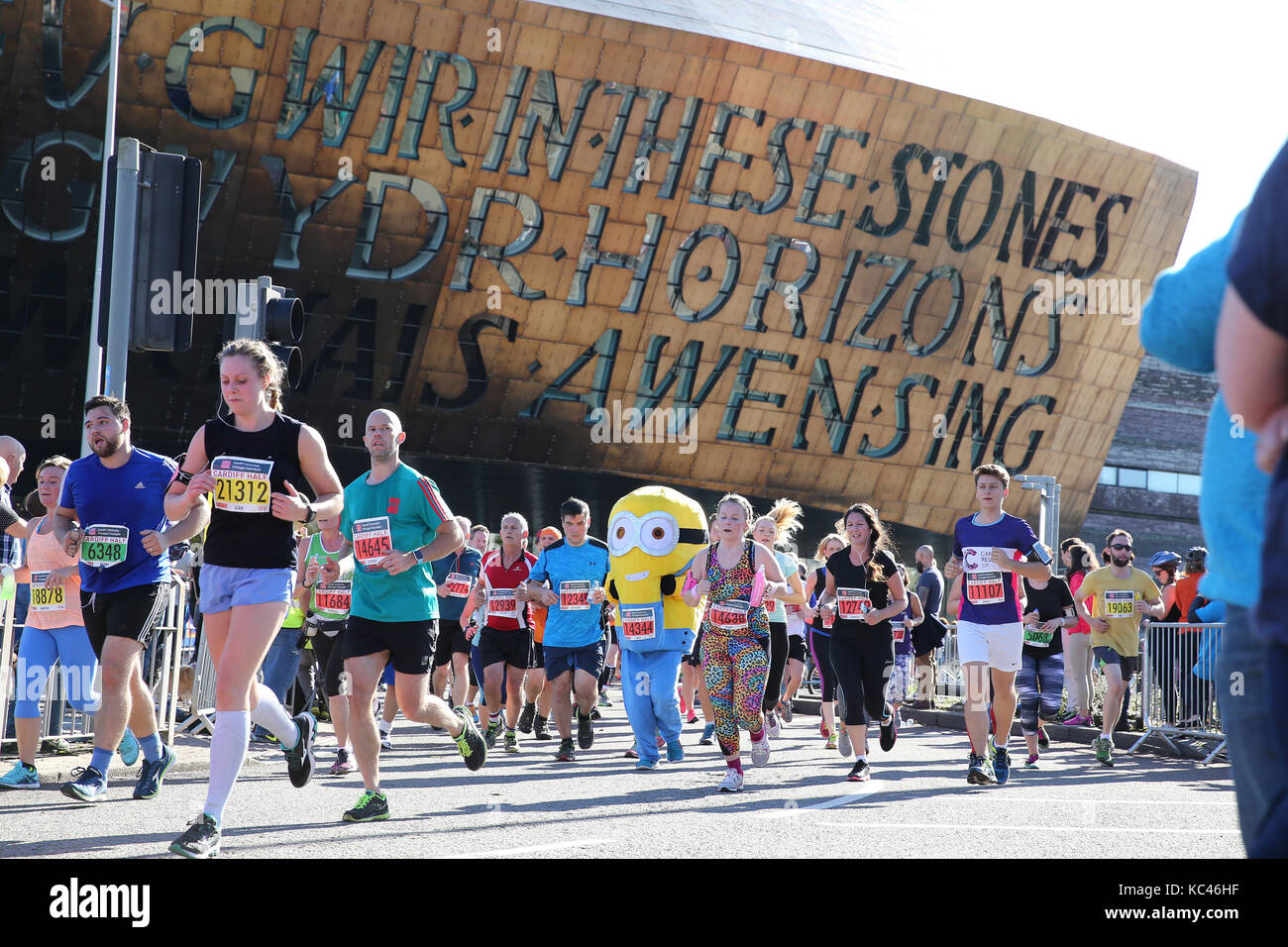 runners pass the Millennium Centre during the Cardiff Half Marathon ...