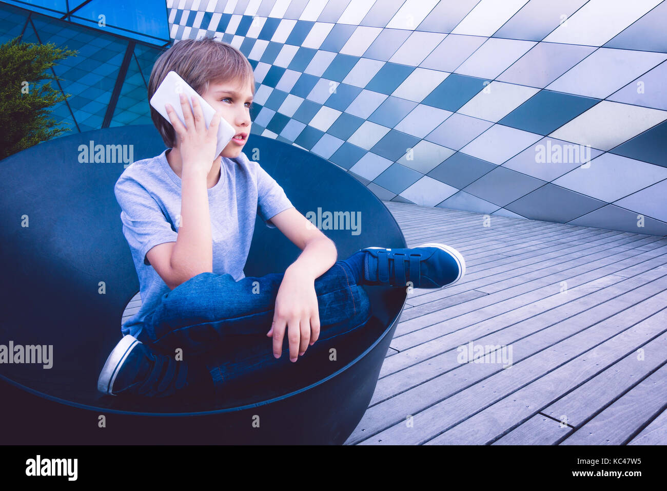 Boy talking on cell phone in the street Stock Photo - Alamy