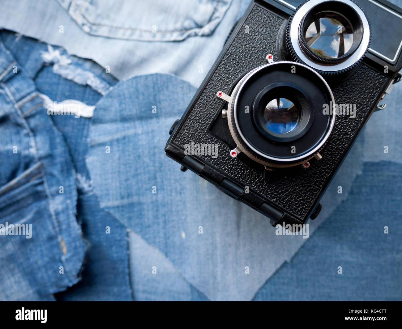 A vintage twin lens camera on a denim background Stock Photo - Alamy