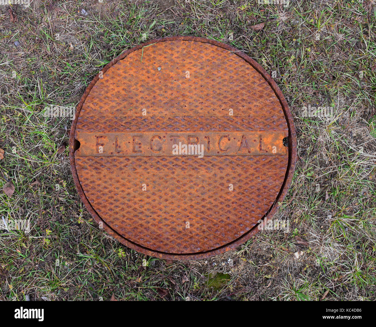 Old rusty electrical manhole cover in a grassy field Stock Photo - Alamy