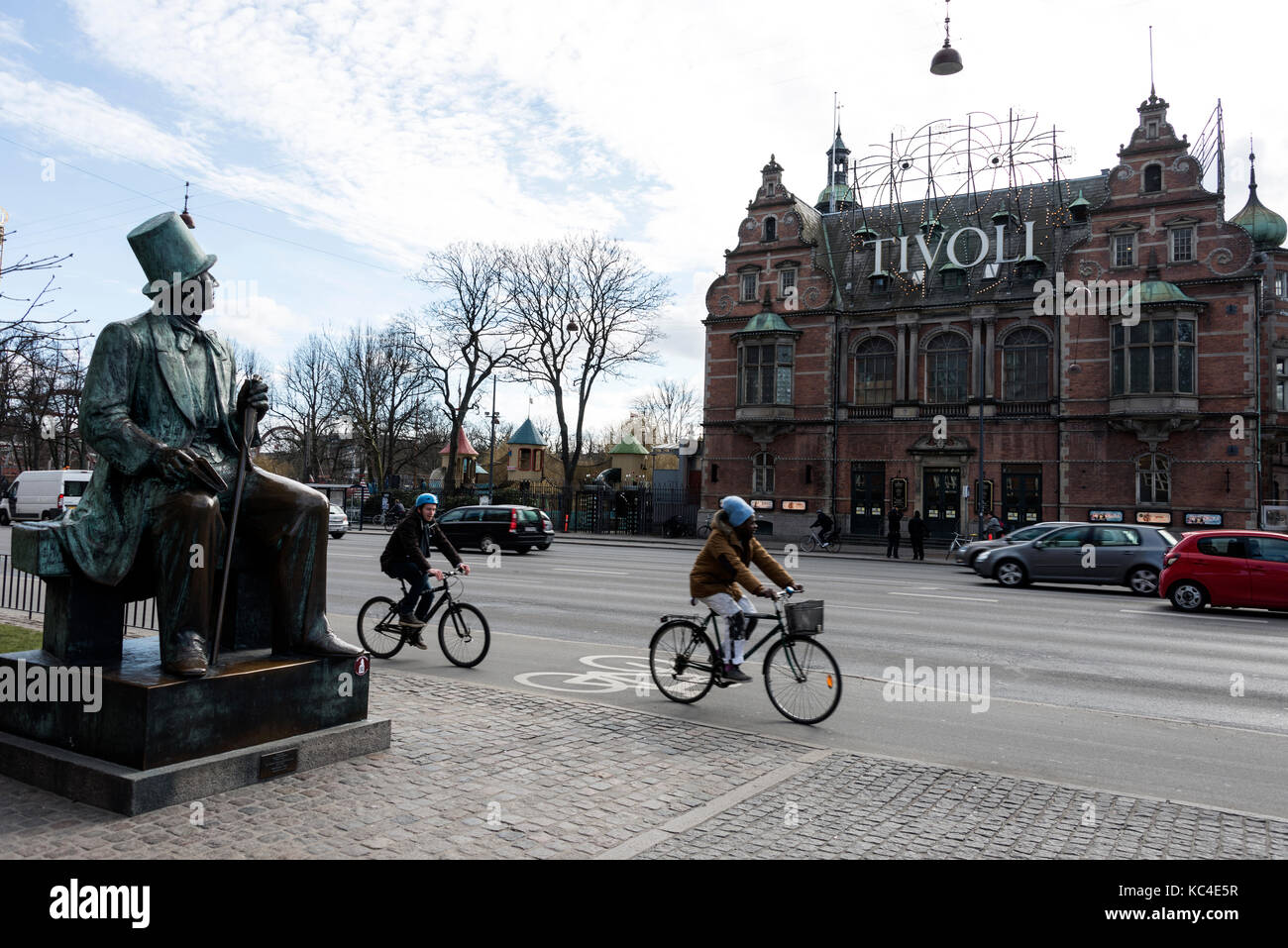 A couple of cyclists pass the statue of famous fairy story author, Hans ...