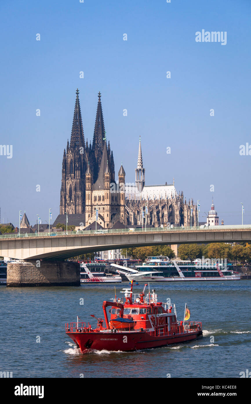 Germany, Cologne, a fire-fighting boat on the river Rhine in front of ...