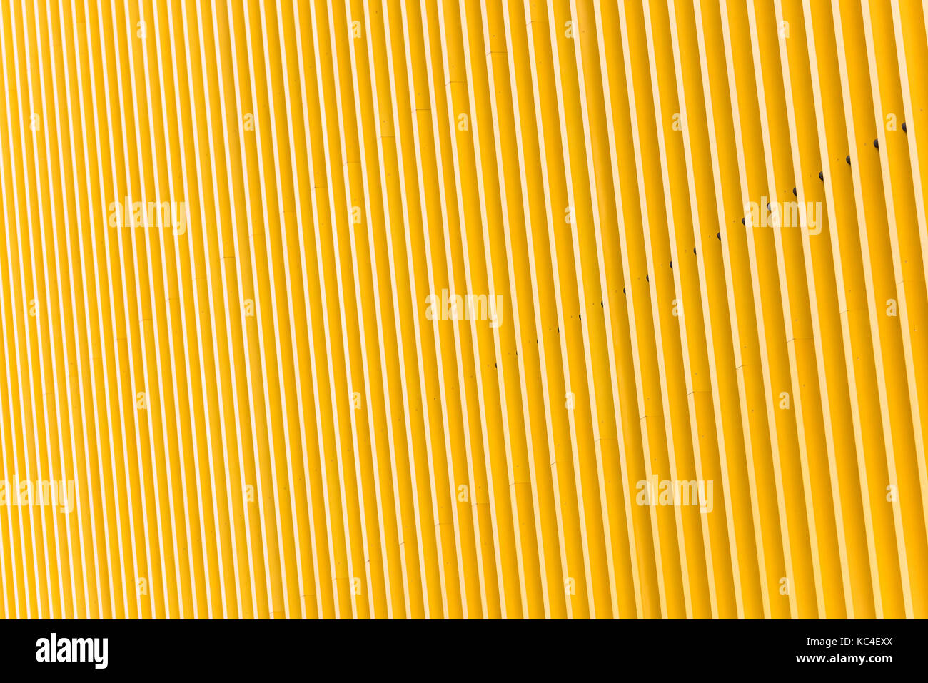 Detail of bright yellow metal building facade. For background Stock ...
