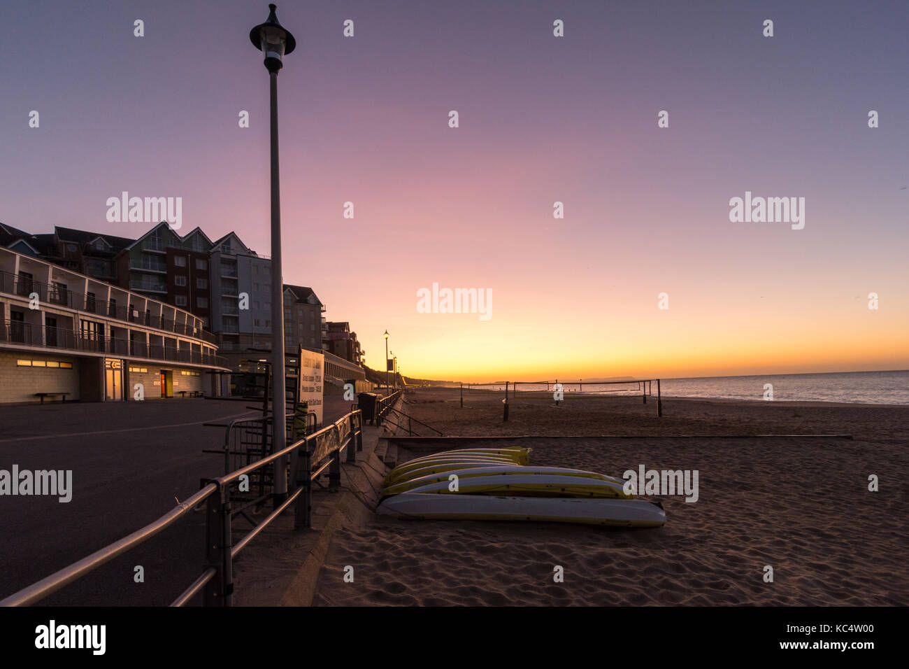 Cloudless skies above the beach as the morning sunlight edges above the ...