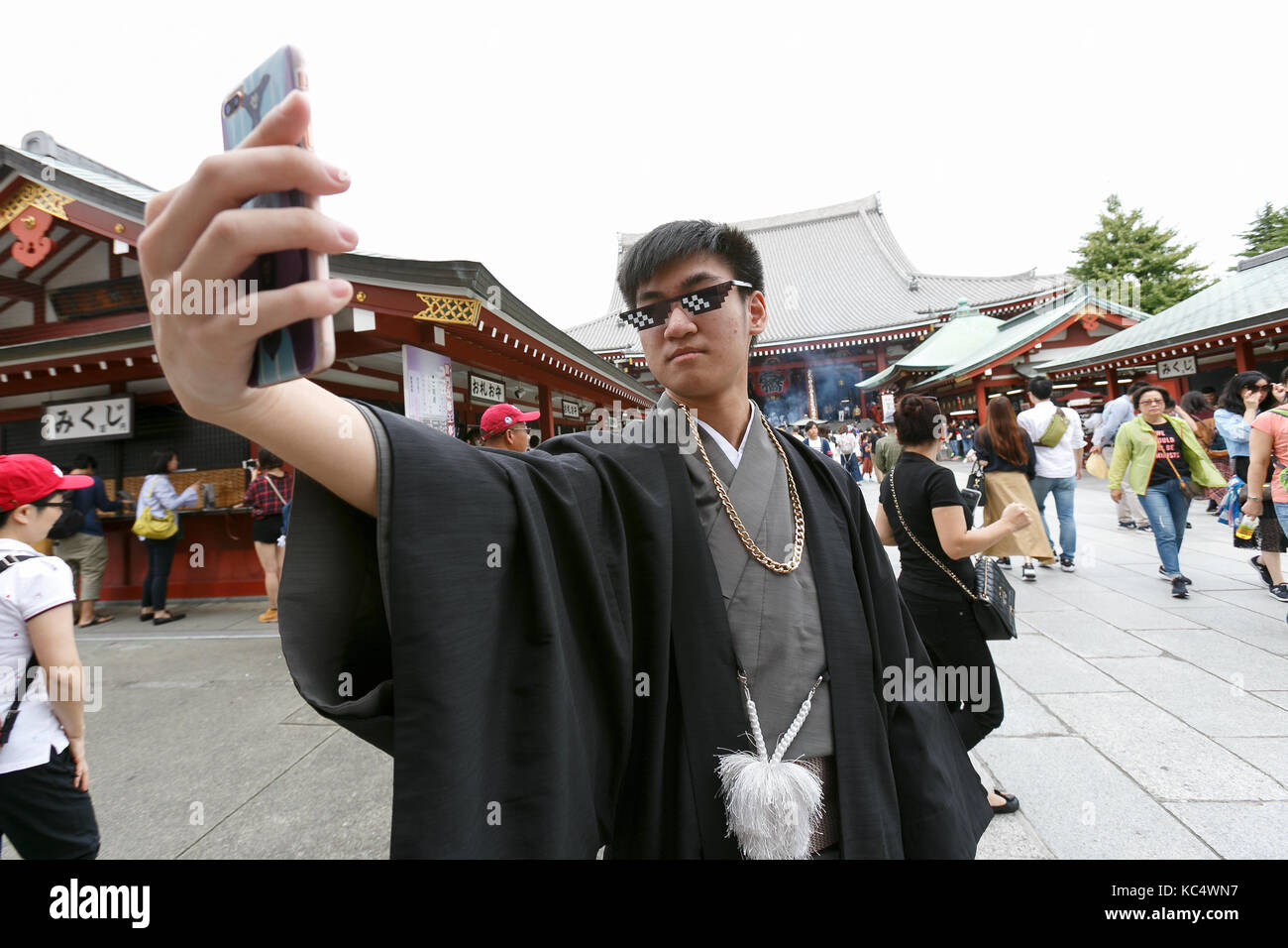 A Hong Kongese tourist dressed in traditional Japanese kimono poses for ...